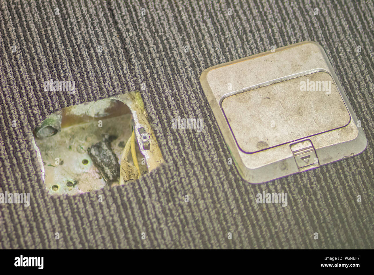 View of pop up floor outlet socket during installation. Opened pop up ...