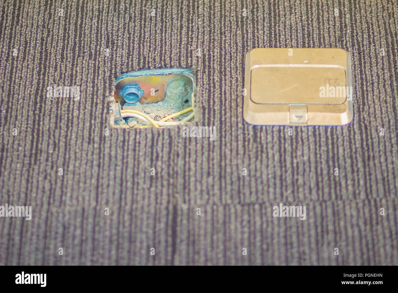 View of pop up floor outlet socket during installation. Opened pop up ...