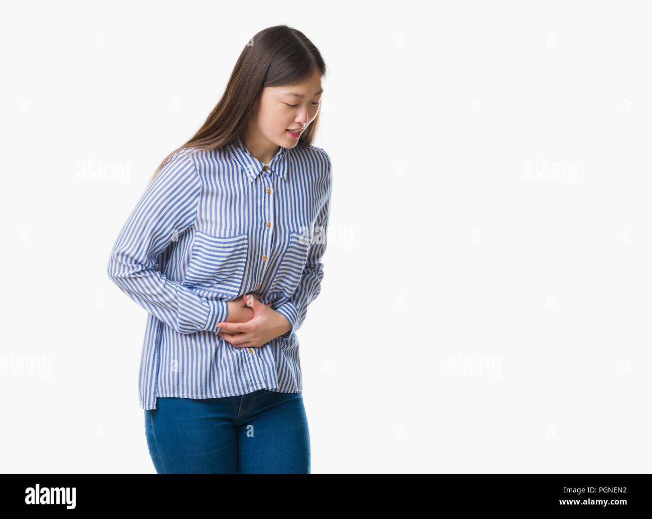 Young Chinese woman over isolated background with hand on stomach ...