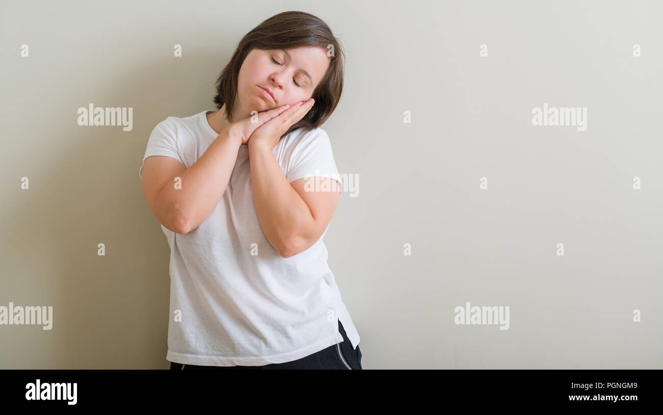 Down syndrome woman standing over wall sleeping tired dreaming and ...