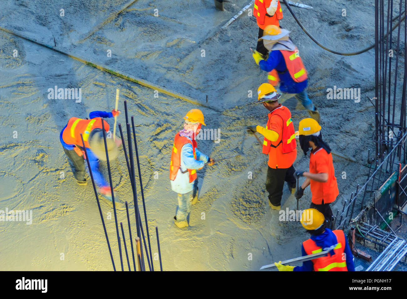 Mason worker leveling concrete with trowels, mason hands spreading ...