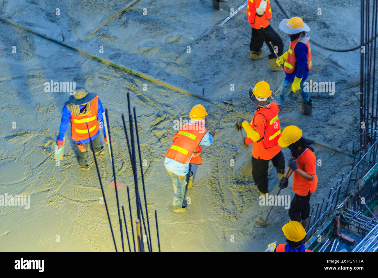 Mason worker leveling concrete with trowels, mason hands spreading ...