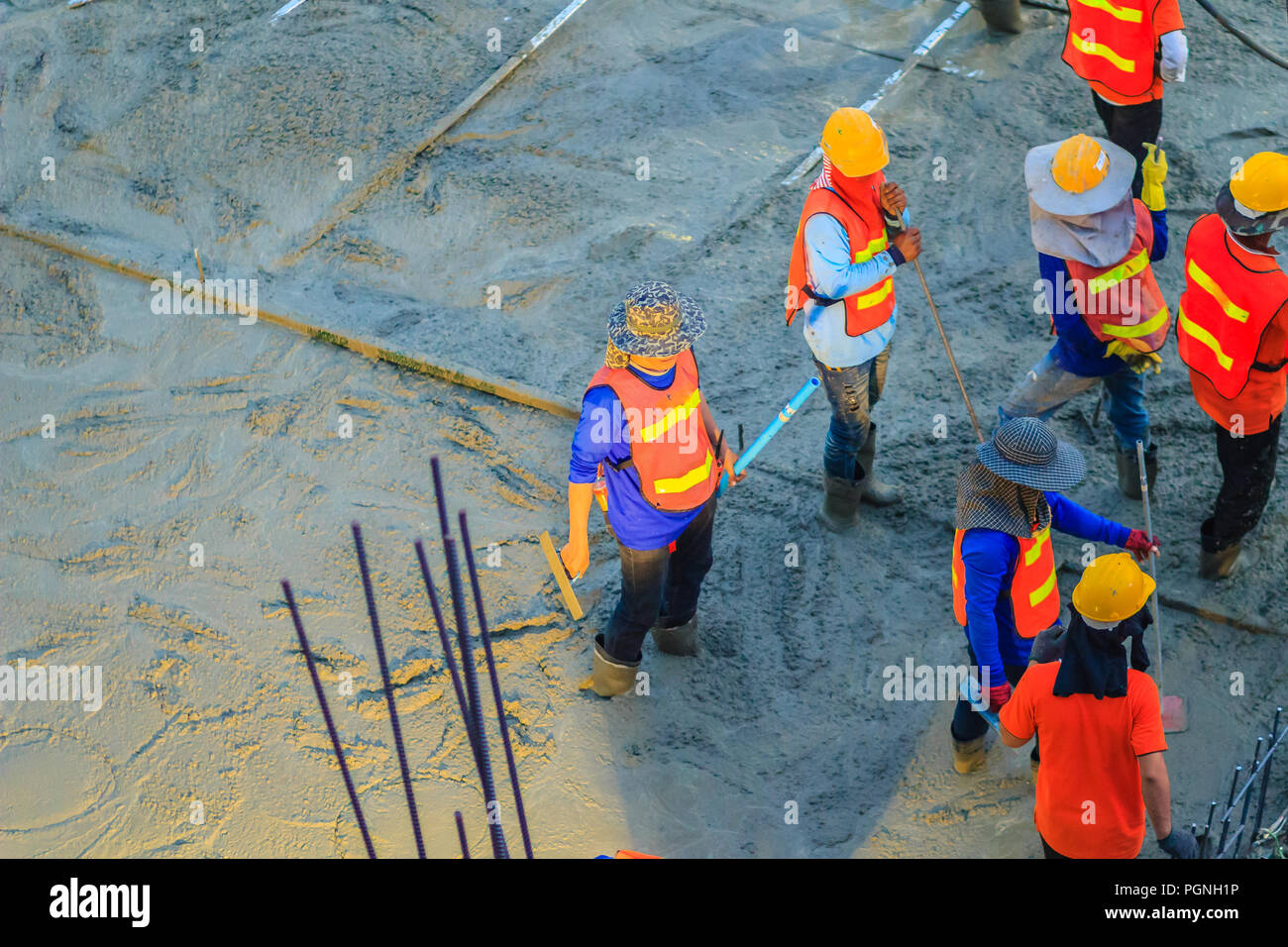 Mason worker leveling concrete with trowels, mason hands spreading ...