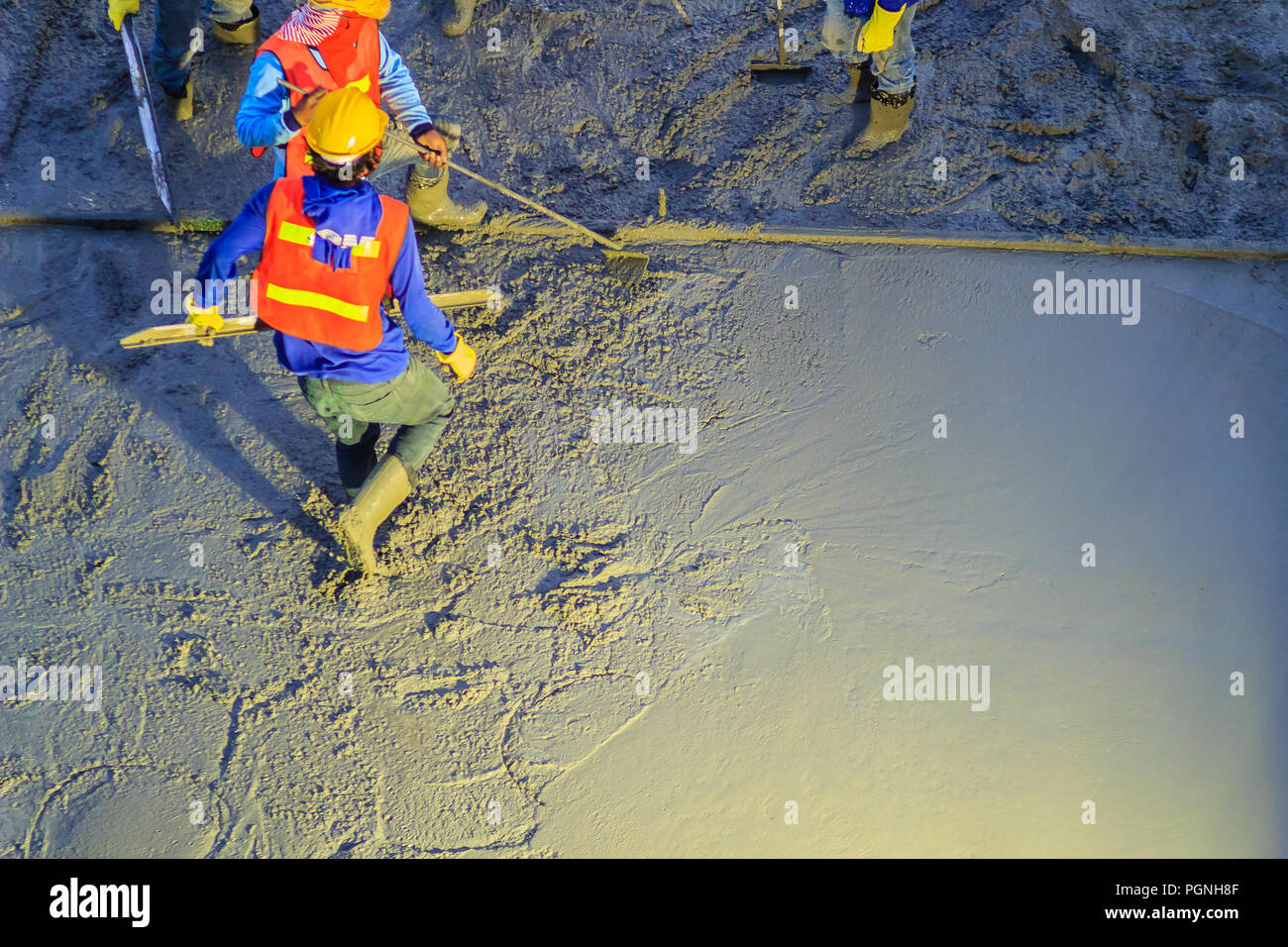 Mason worker leveling concrete with trowels, mason hands spreading ...