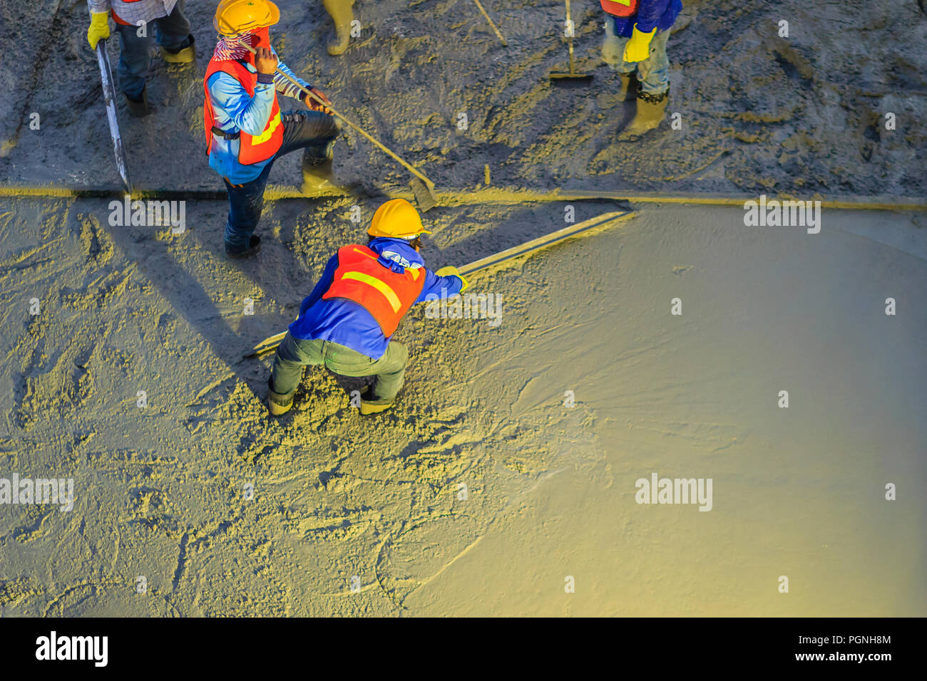 Mason worker leveling concrete with trowels, mason hands spreading ...