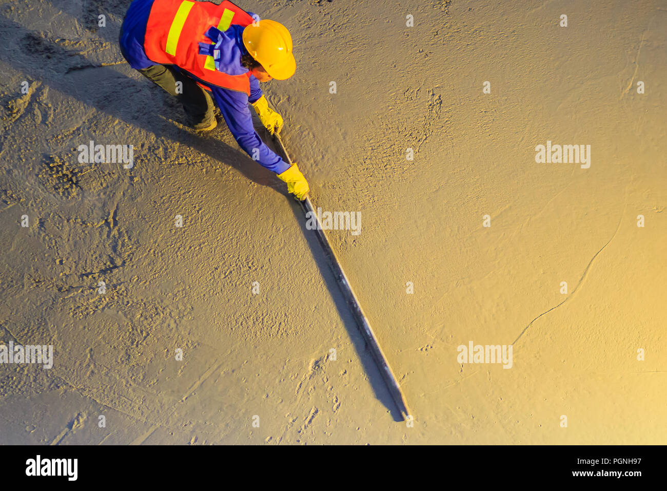 Mason worker leveling concrete with trowels, mason hands spreading ...