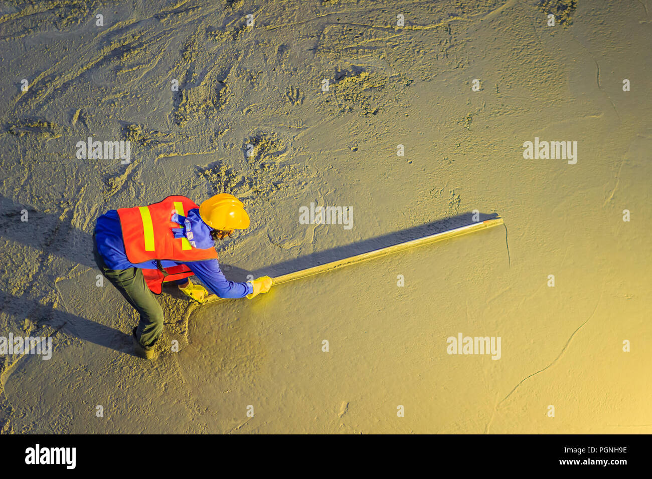 Mason worker leveling concrete with trowels, mason hands spreading ...