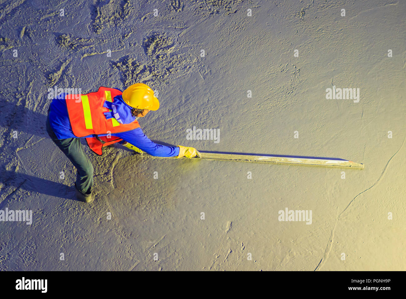 Mason worker leveling concrete with trowels, mason hands spreading ...