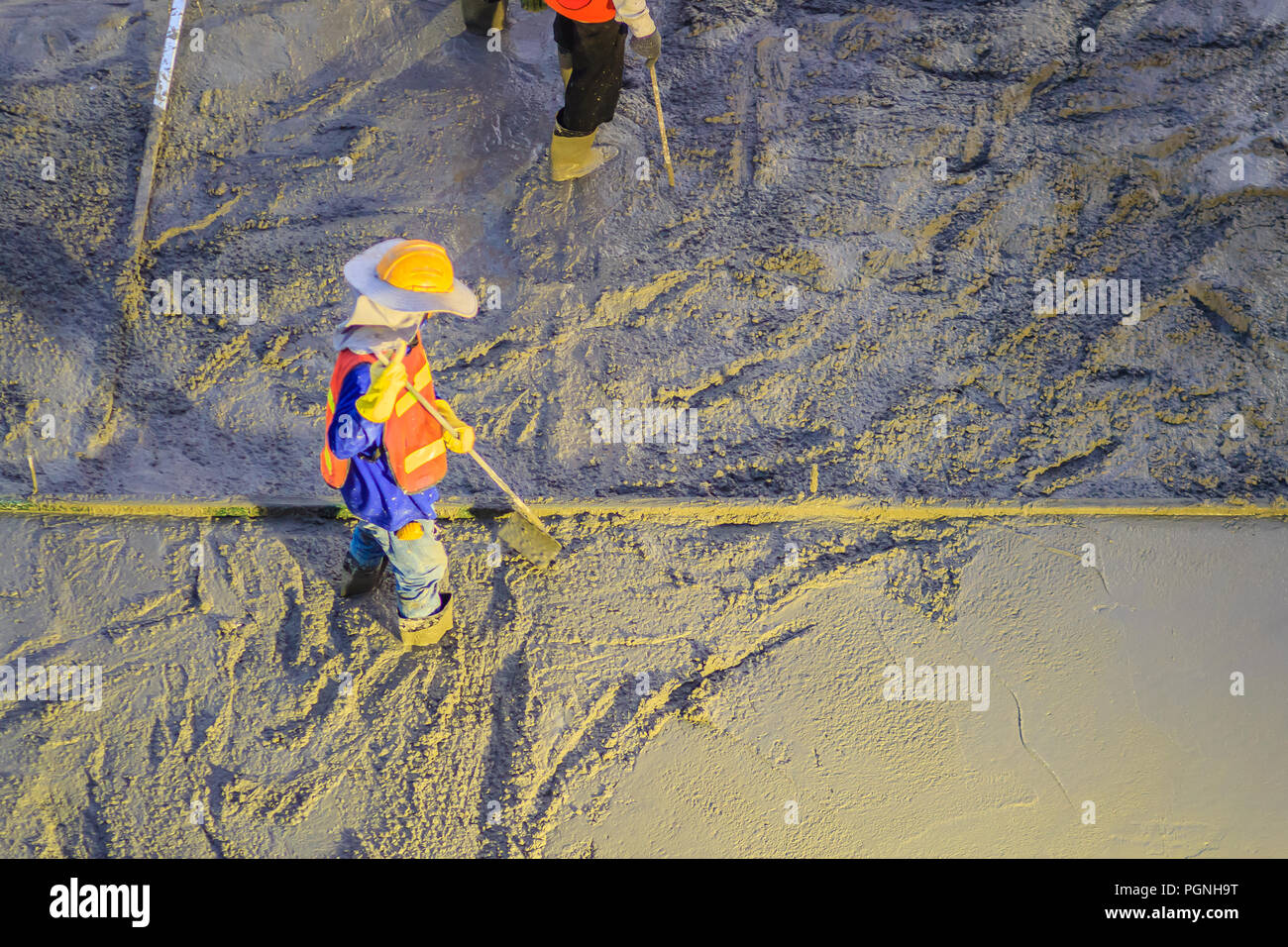 Mason worker leveling concrete with trowels, mason hands spreading ...