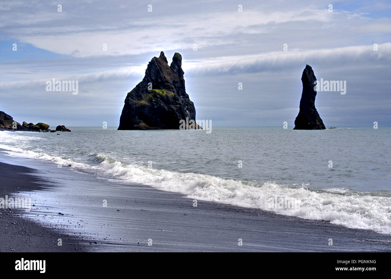 Black beach and sea rocks in Iceland Stock Photo - Alamy