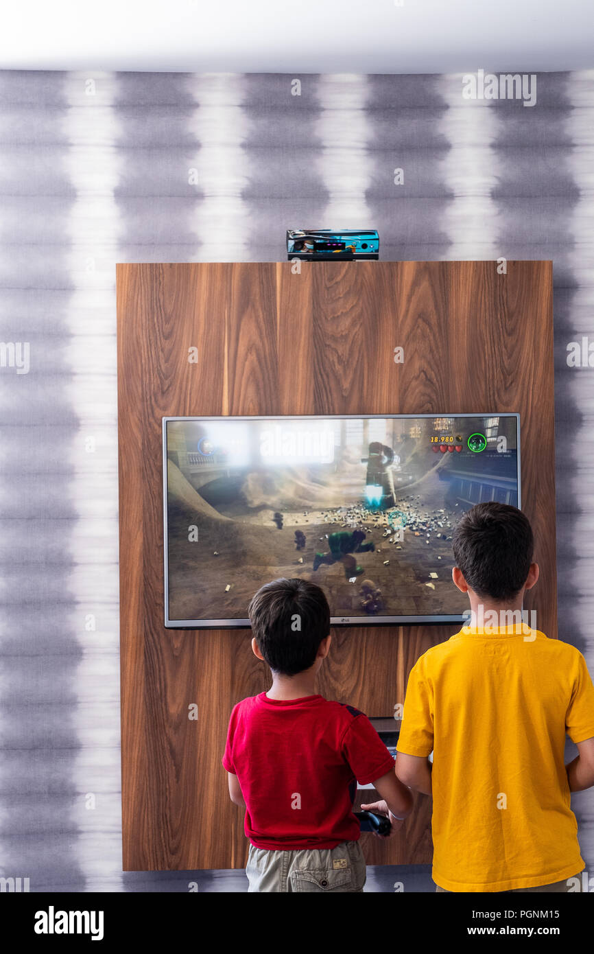 Kids playing video game on console Stock Photo - Alamy