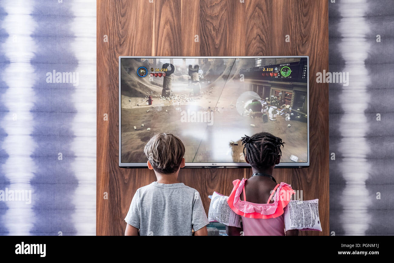 Kids playing video game on console Stock Photo - Alamy