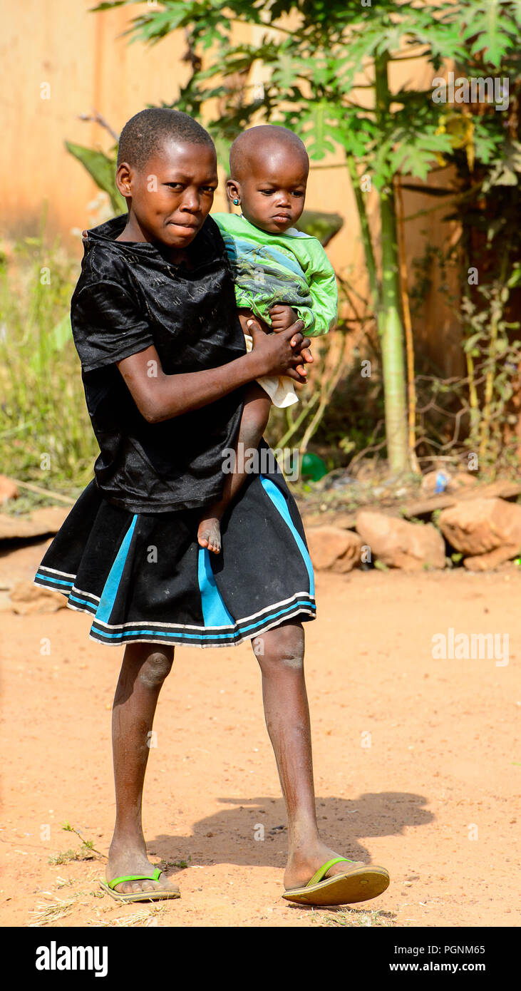 KARA REG., TOGO - JAN 14, 2017: Unidentified Konkomba girl carries a ...