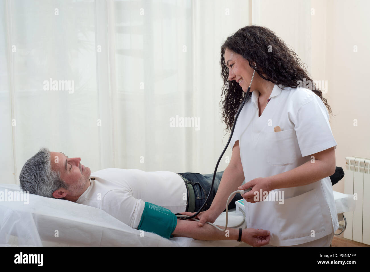 doctor takes the pressure blood to patient stretched in stretcher Stock ...