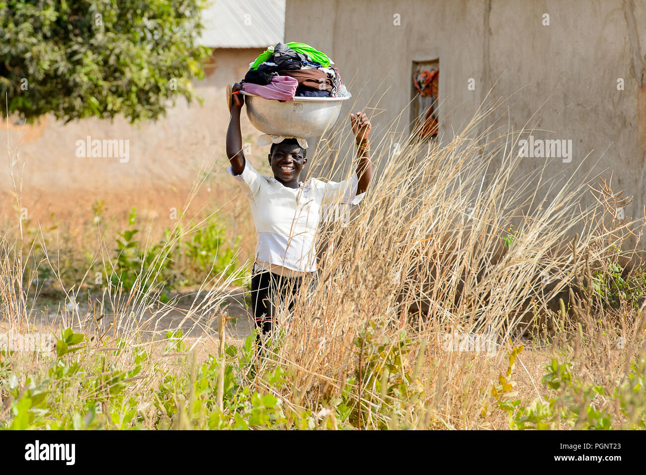 GHANI, GHANA - JAN 14, 2017: Unidentified Ghanaian boy carries a basin ...