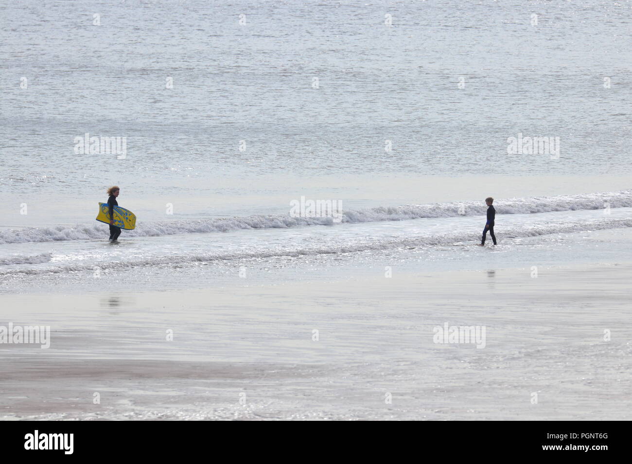 A female with a paddle board at Reighton Gap on the Yorkshire Coastline ...