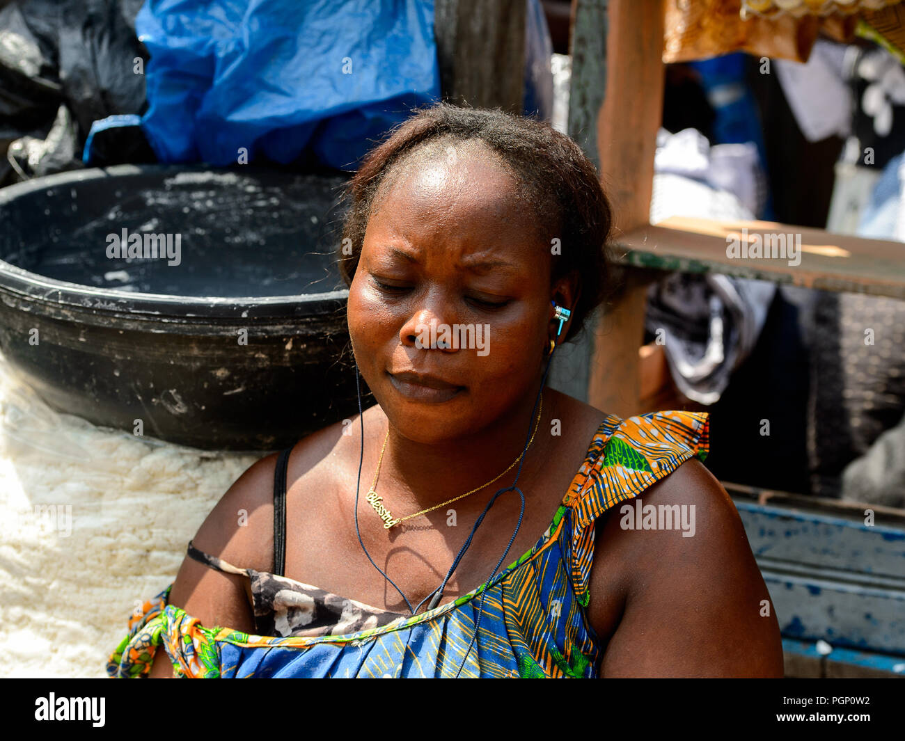 KUMASI, GHANA - JAN 15, 2017: Unidentified Ghanaian woman listens to ...