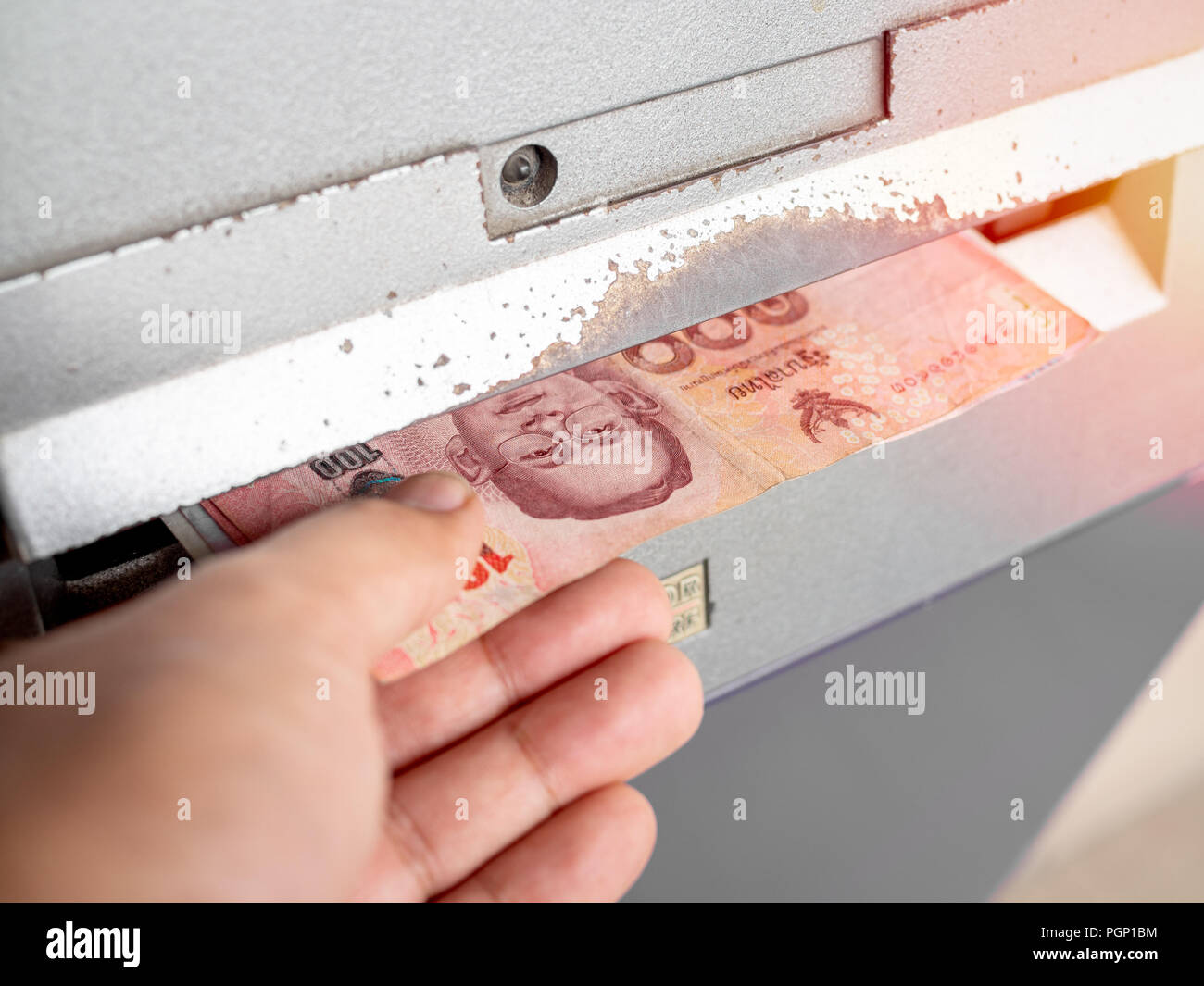 Close-up hand withdraw money, the red banknotes one hundred thai baht ...