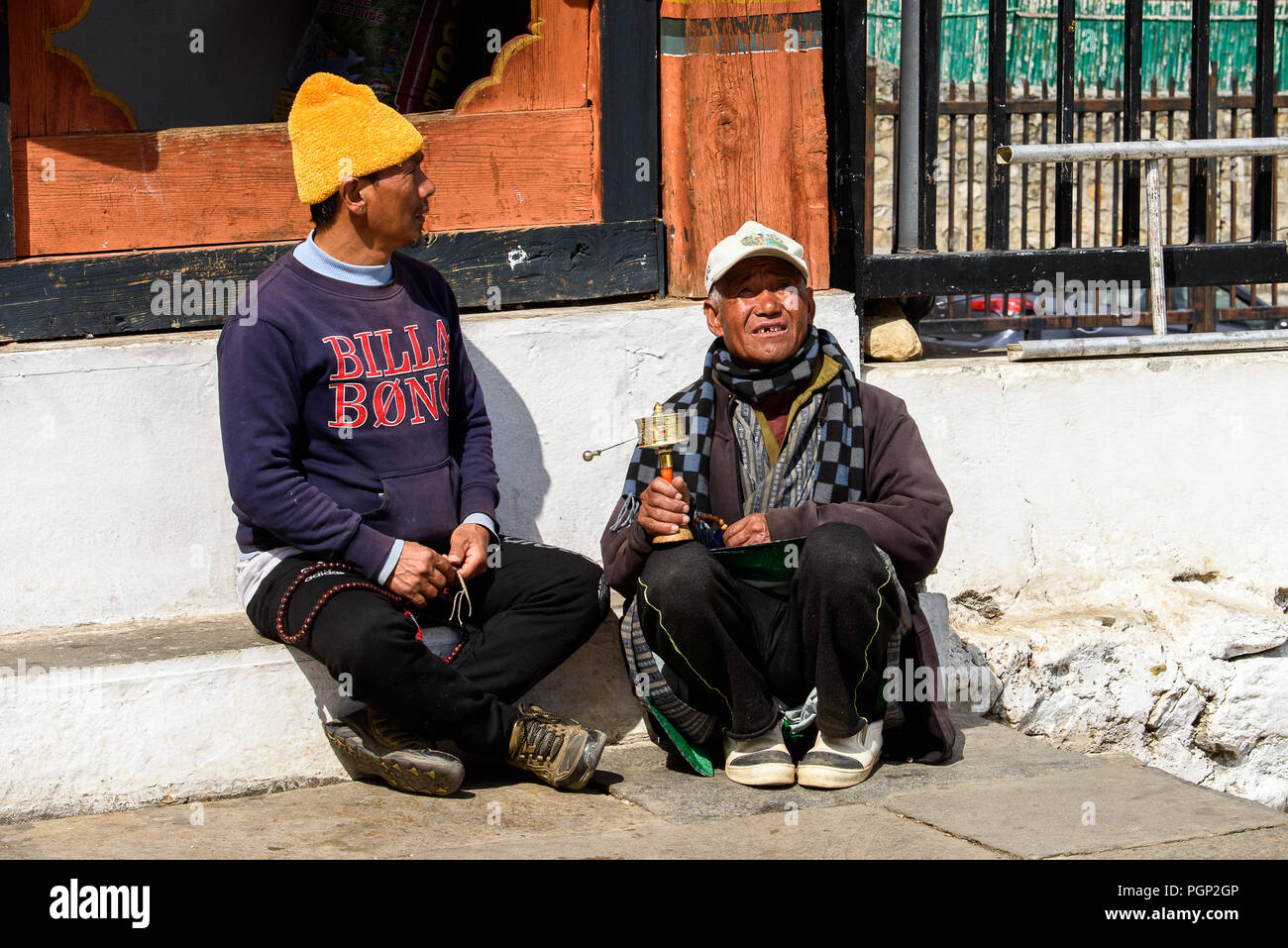 TRIMPHU, BHUTAN - MAR 8, 2017: Unidentified Ngalops people sit beside ...
