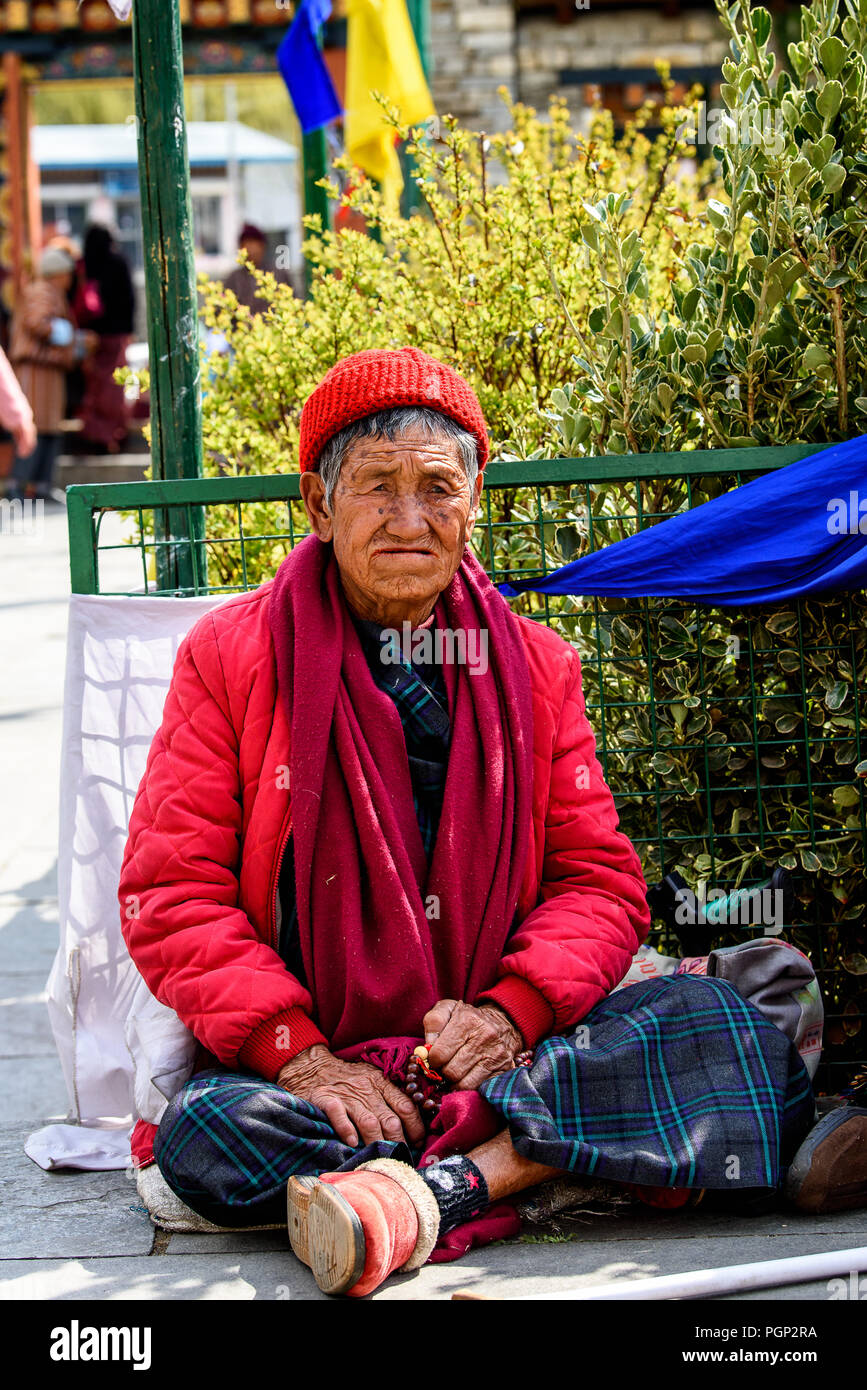 TRIMPHU, BHUTAN - MAR 8, 2017: Unidentified Ngalops old man holds beads ...