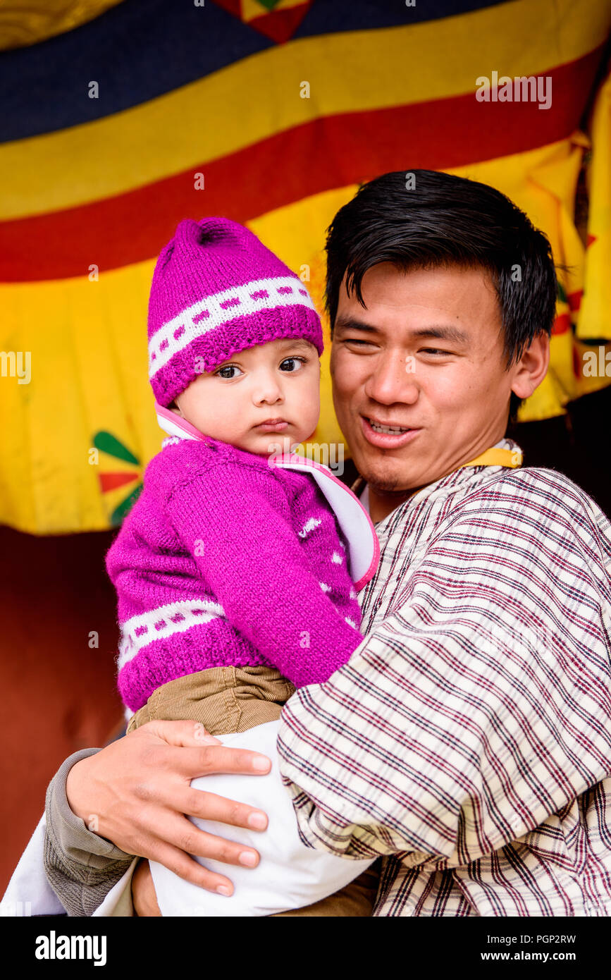 TRIMPHU, BHUTAN - MAR 8, 2017: Unidentified Ngalops man carries a baby ...