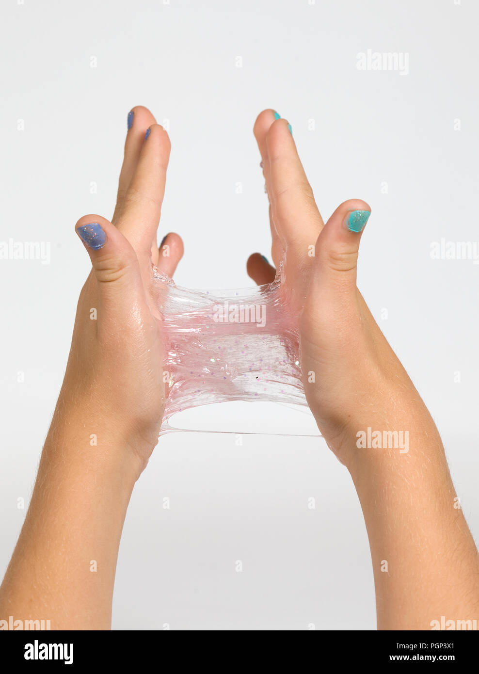 Hands covered in unicorn poo slime Stock Photo - Alamy