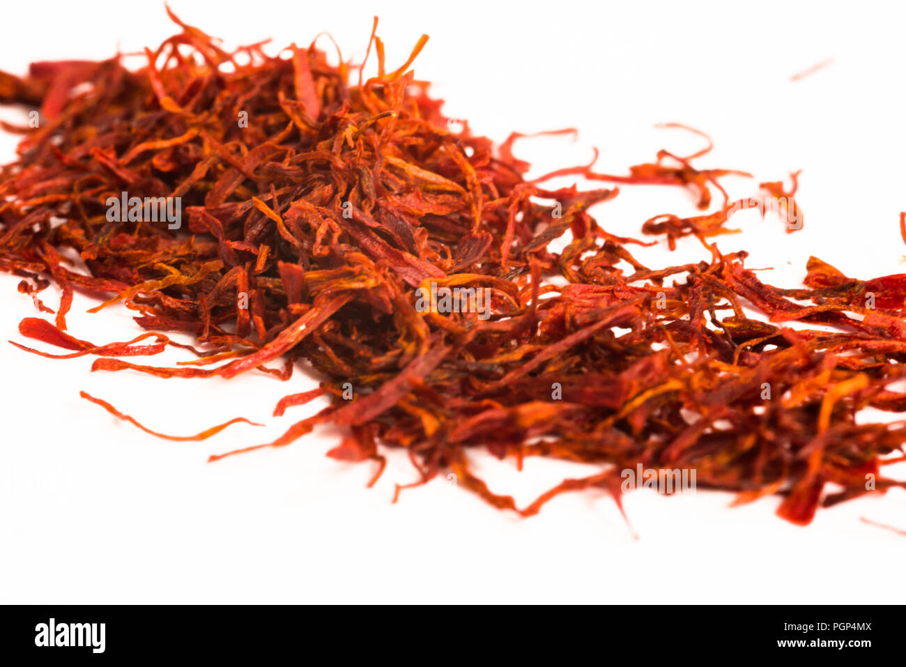 Saffron threads shown in detail on a white background Stock Photo - Alamy