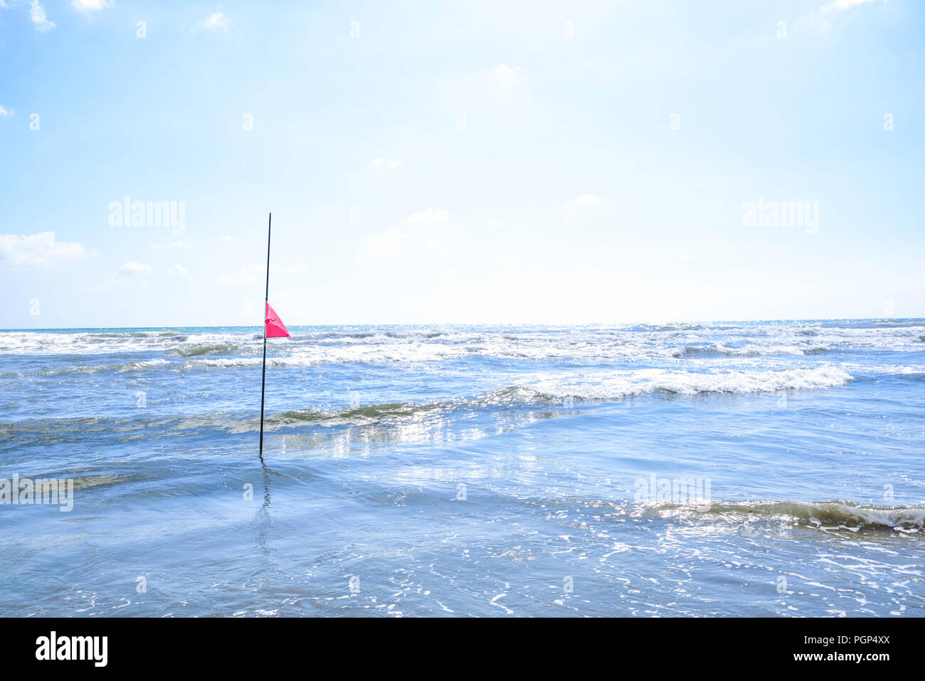 Rough sea. Bathing danger red flag Stock Photo - Alamy