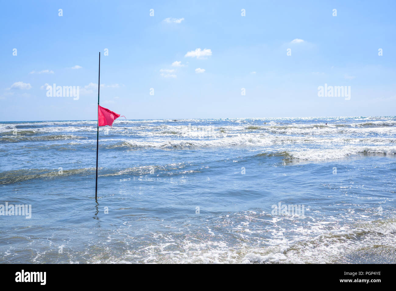 Rough sea. Bathing danger red flag Stock Photo - Alamy