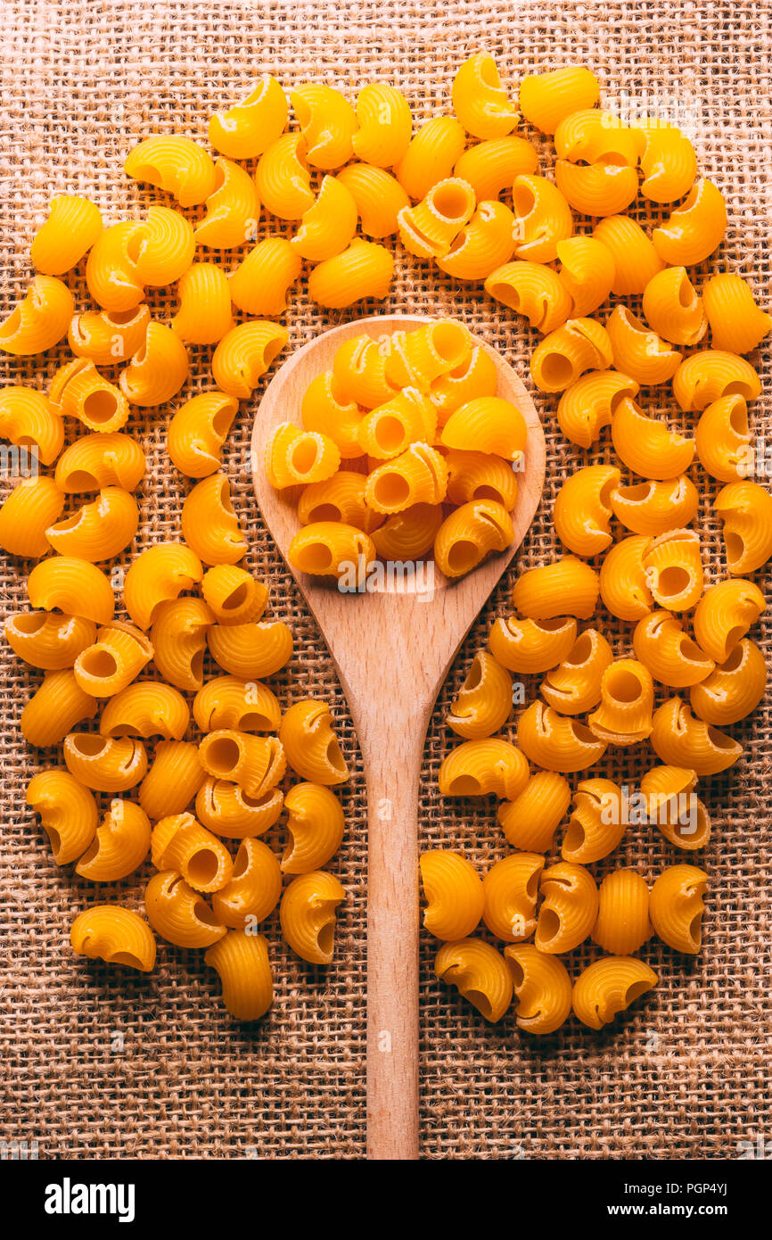 Italian Pasta Gomiti Rigati, Carbohydrates on rustic background Stock ...