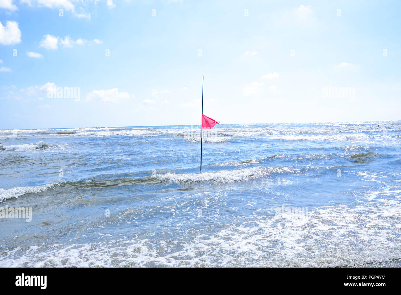 Rough sea. Bathing danger red flag Stock Photo - Alamy
