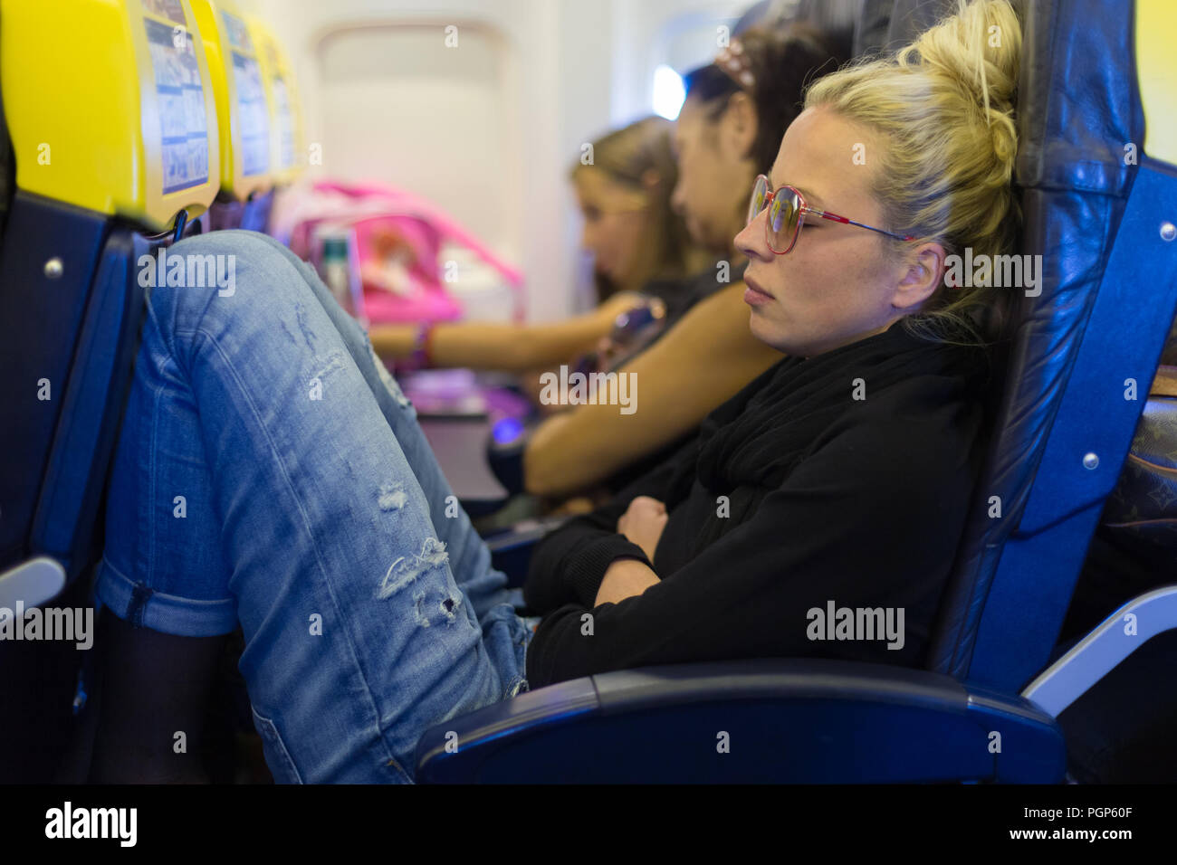People flying by plane. Interior of airplane with passengers sleeping ...