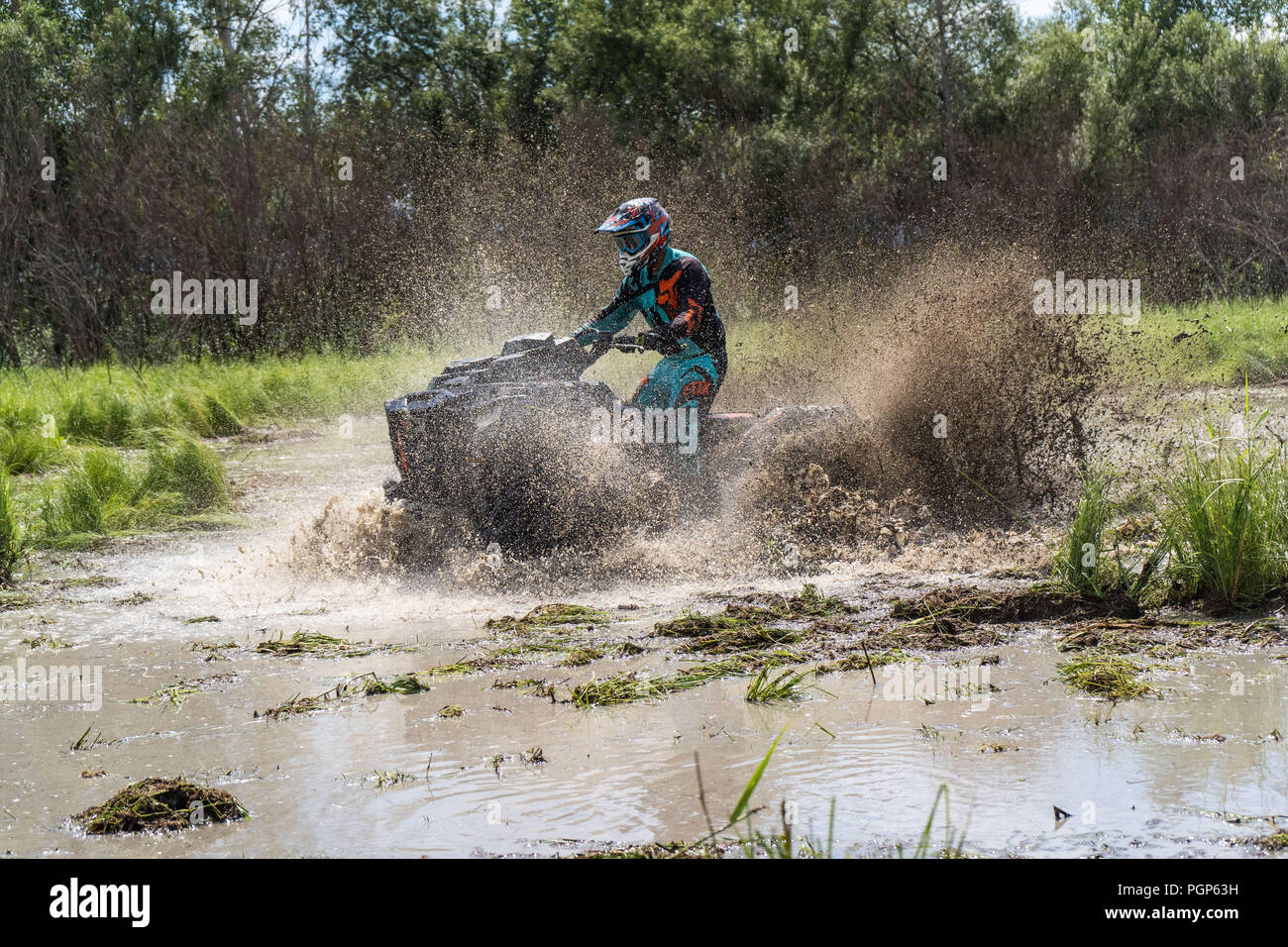 ATV Quad polaris rides fast on big dirt and makes splashes of dirty ...