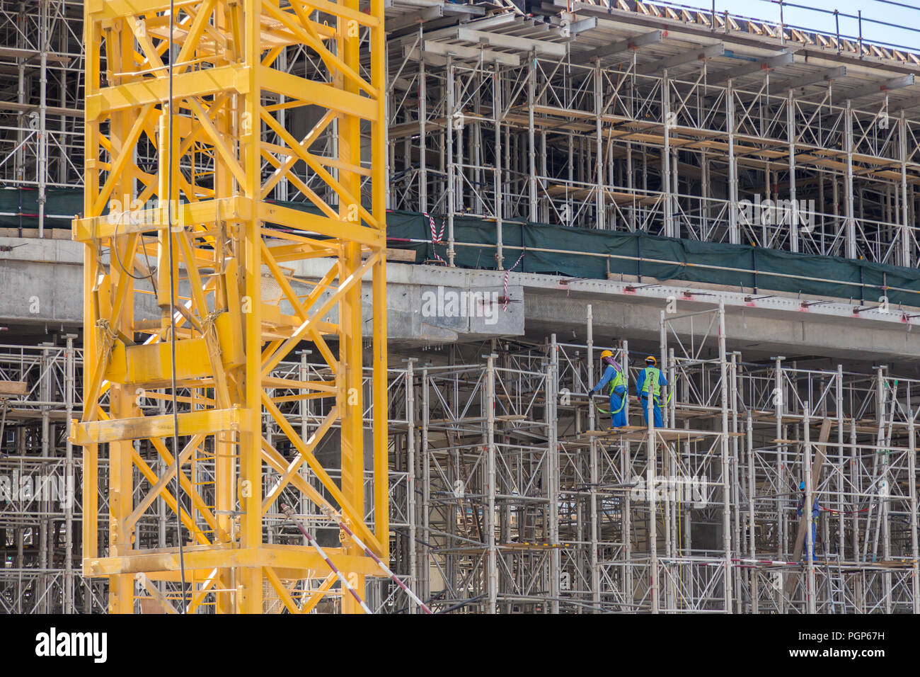 Construction site with team of construction laborers working on ...