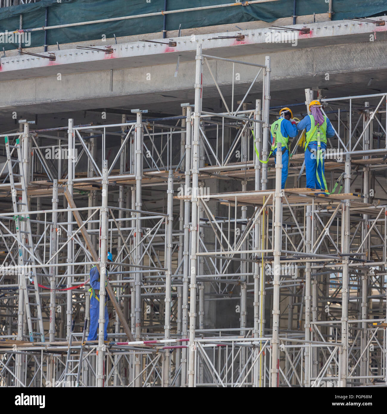 Construction site with team of construction laborers working on ...