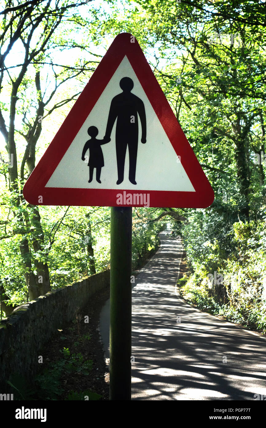 Silhouette illustration of adult holding a childs hand on a triangular ...