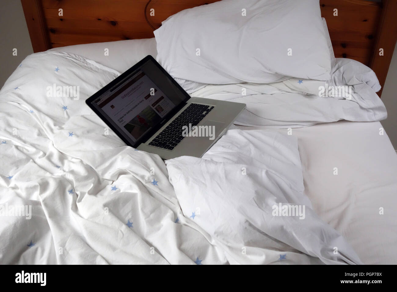 Laptop left on bed hi-res stock photography and images - Alamy