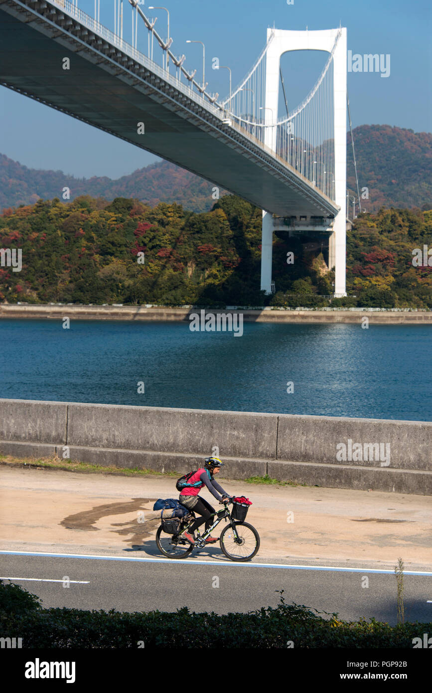 Mathilde Collignon from France cycles past the Oshima Ohashi Bridge ...