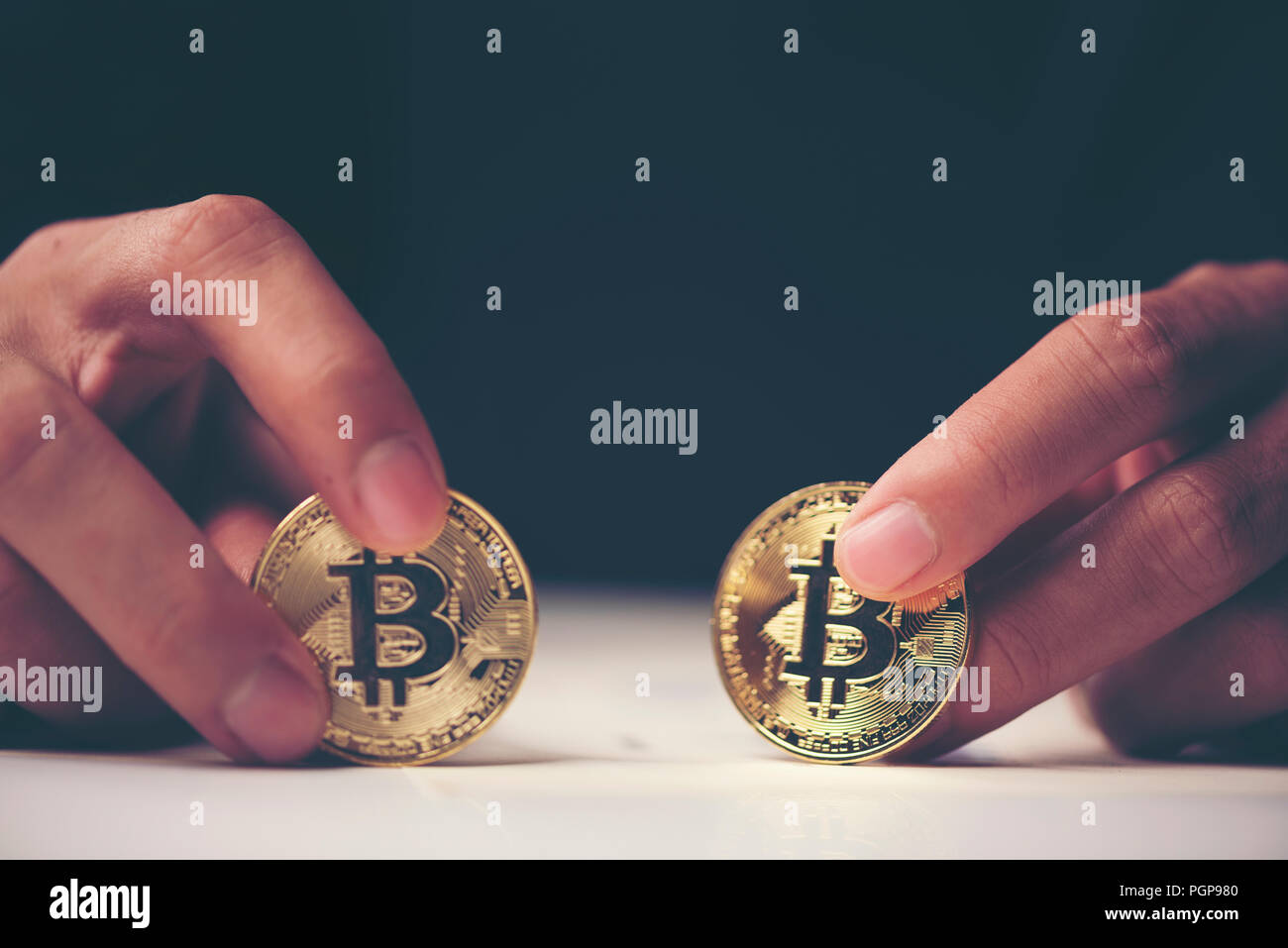 Golden Bitcoin in a man hand, Digitall symbol of a new virtual currency ...