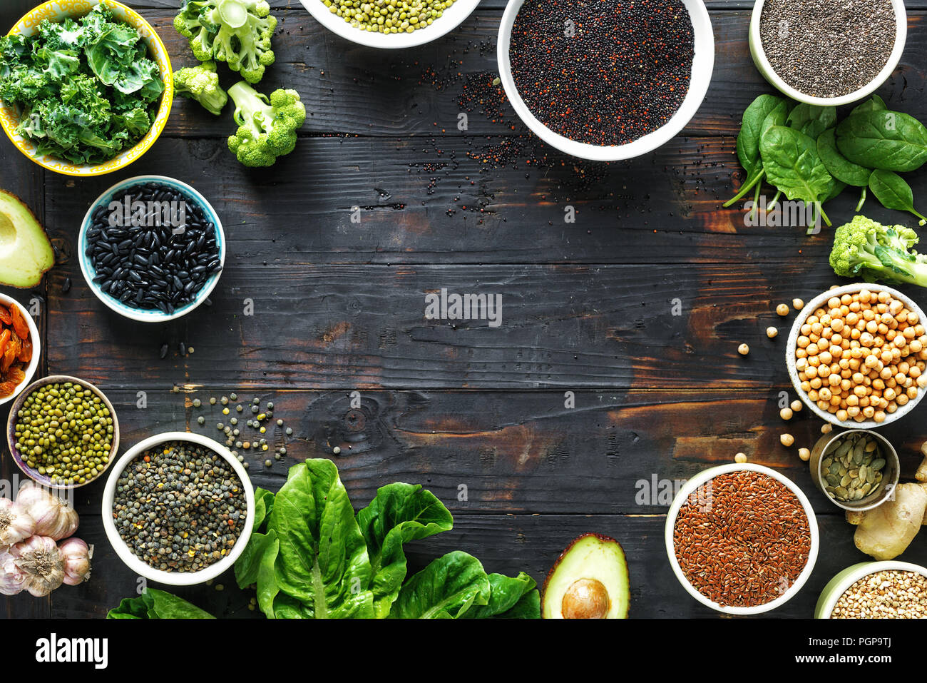 Frame of set raw seeds, cereals, beans, superfoods and green vegetables ...