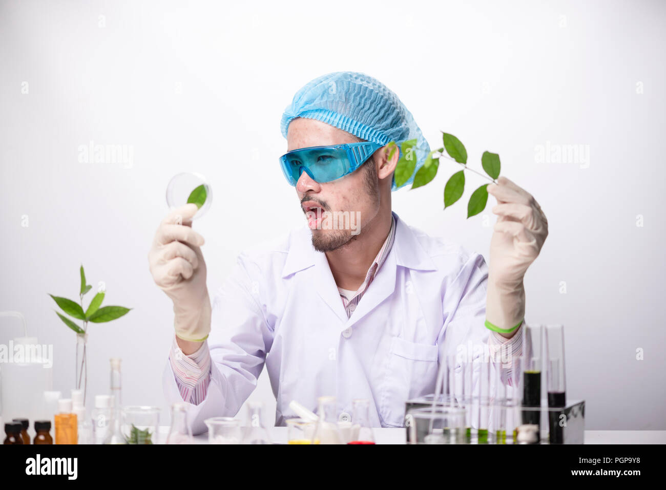 Scientists Looking At Sample Of Plant Working In Genetics Laboratory ...