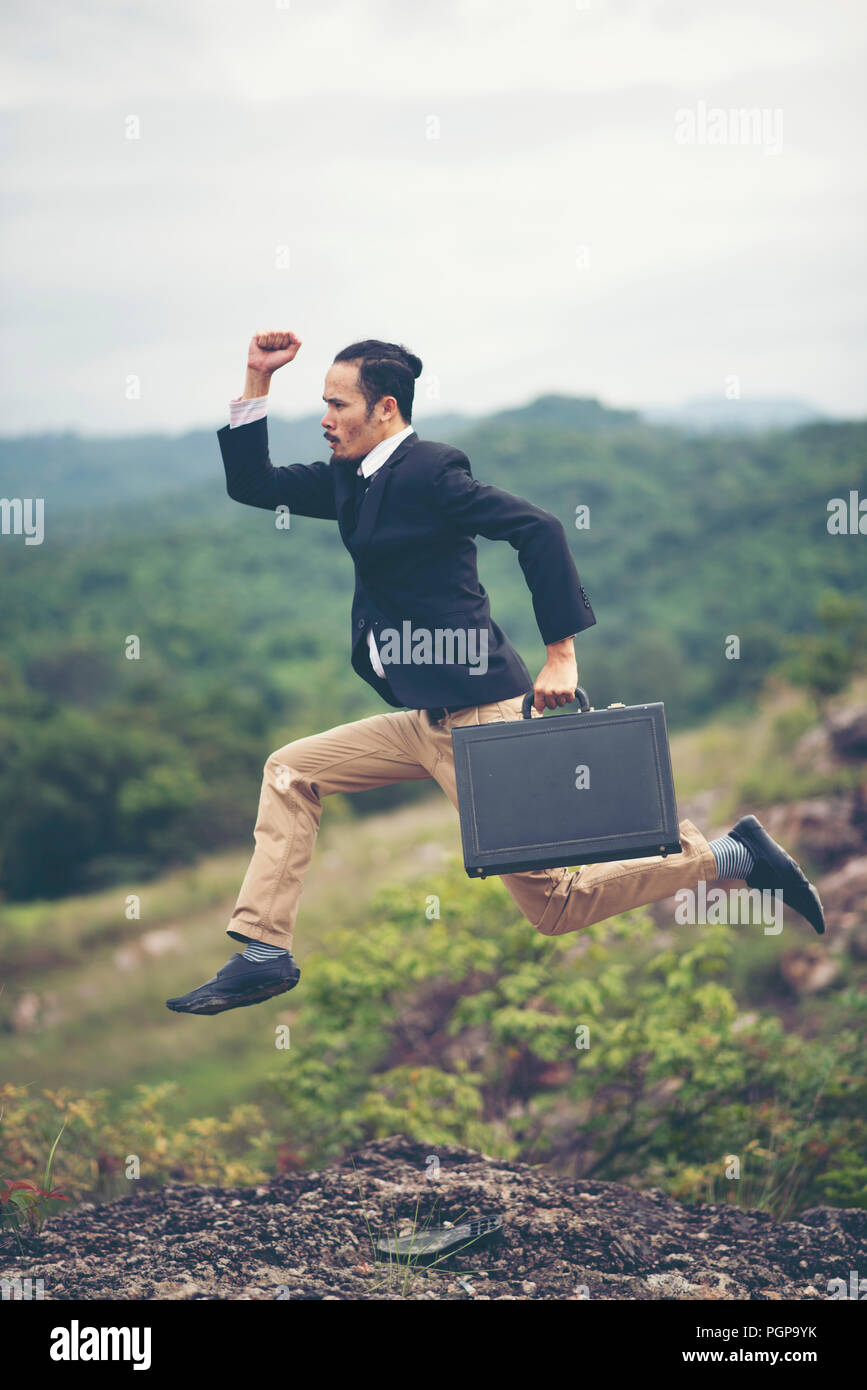 Businessman in suit running in the air as symbol of active life ...