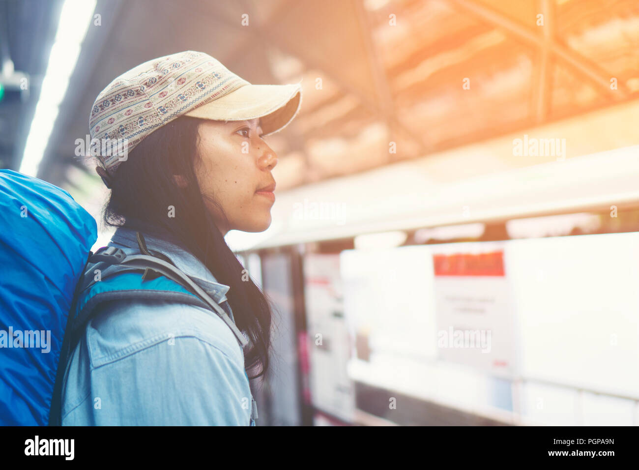 Beautiful young travelers are watching the train schedule Stock Photo ...