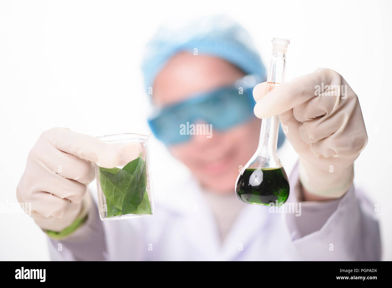 Scientist hand holding green leaf in glass cuvette on laboratory ...