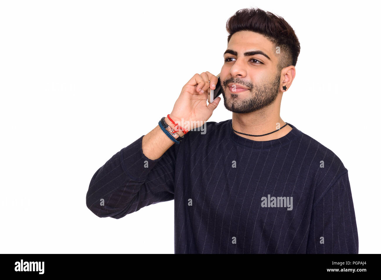 Studio shot of young happy Indian man talking on mobile phone is Stock ...