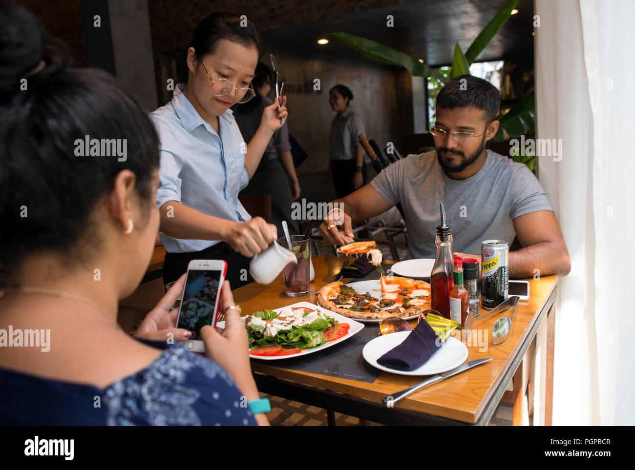 Niranjan and Preeti lalwani Singh from India enjoy pizza at Pizza 4Ps ...