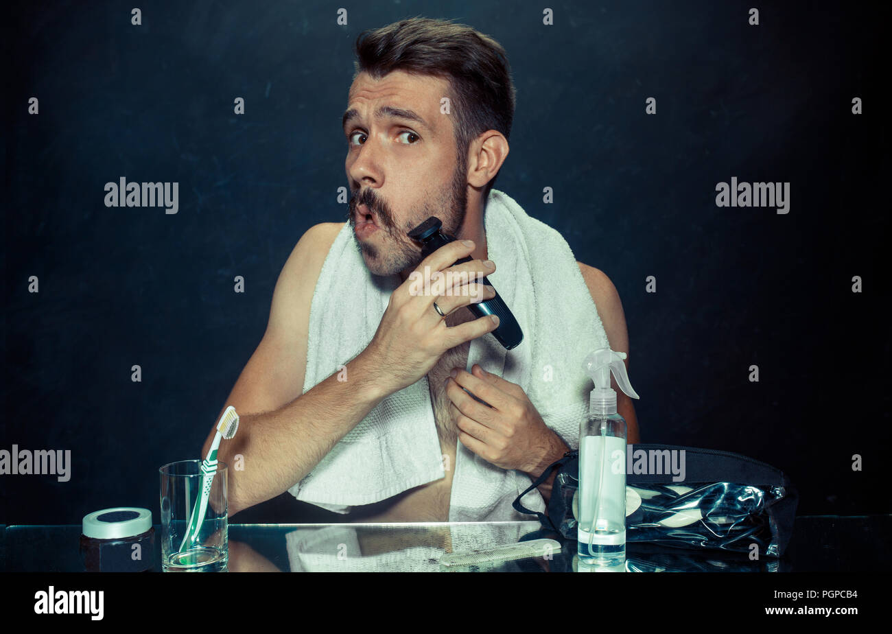 Man shaving face sad hi-res stock photography and images - Alamy