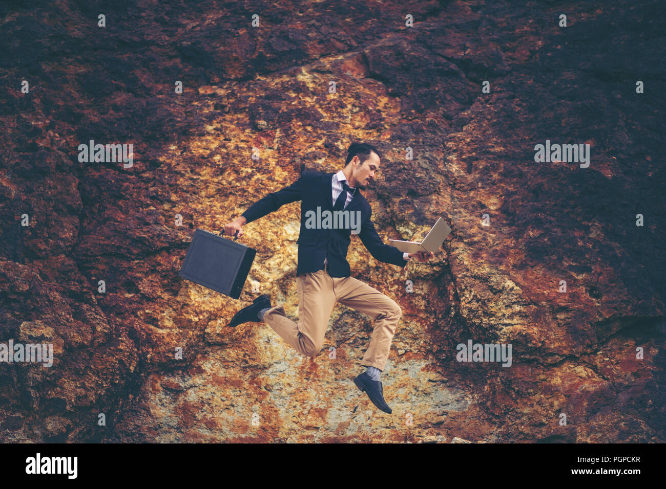 Business man jump dangerous mountain hi-res stock photography and ...