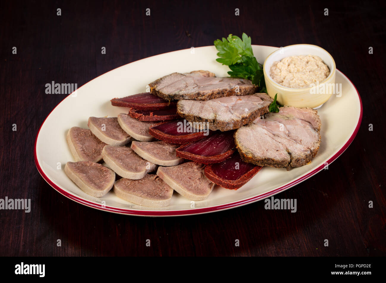 Meat plate mix with tongue and sauce Stock Photo - Alamy