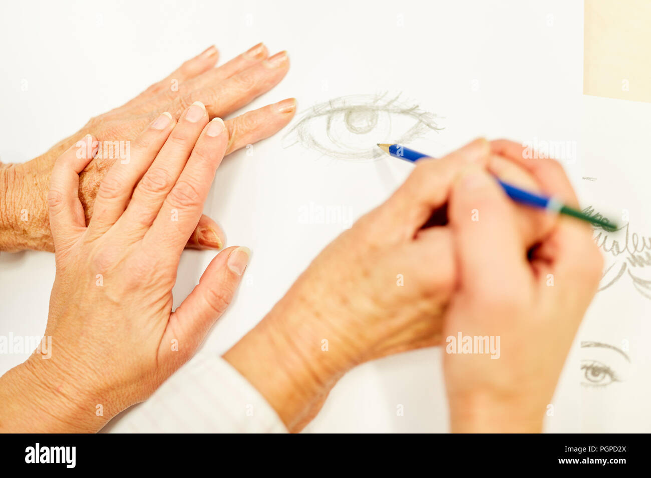 Senior does a drawing in painting therapy and is supported by therapist ...